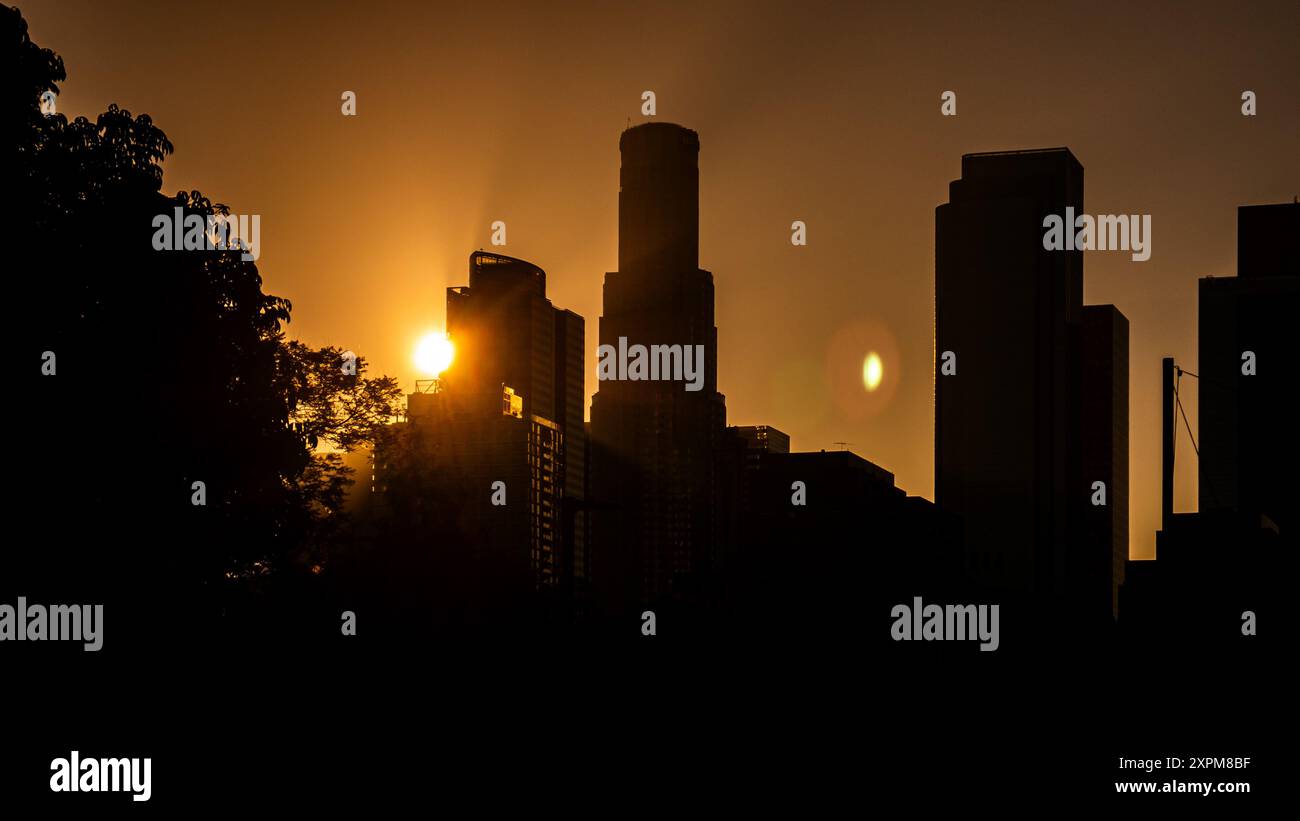 Sun setting behind skyscrapers, skyline of Little Tokyo or Skid Row ...