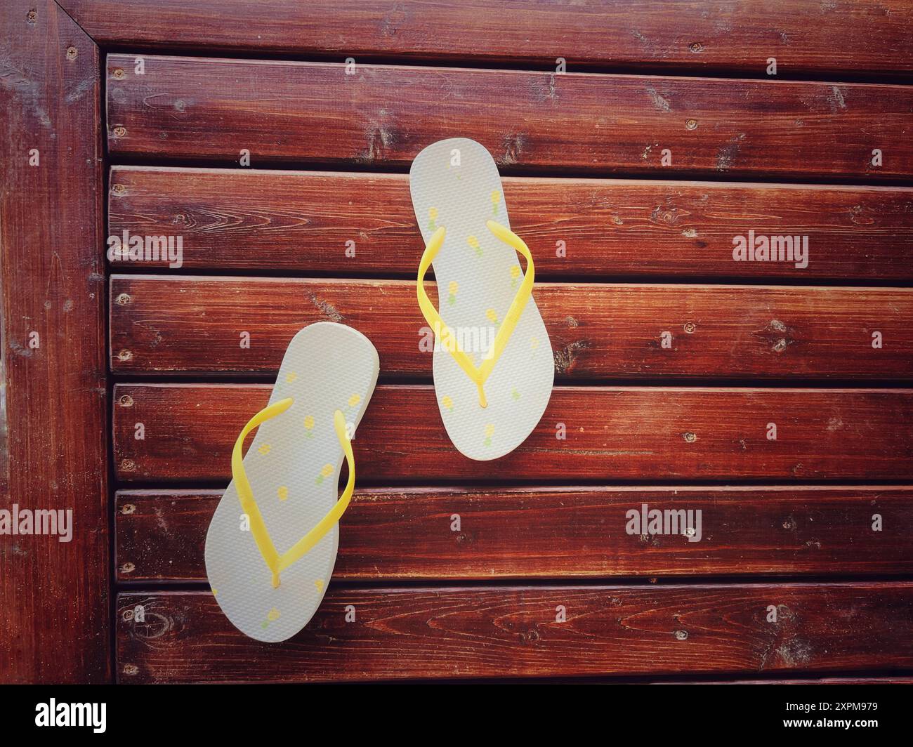 blue and yellow flip flops on wooden floor. Top view Stock Photo - Alamy