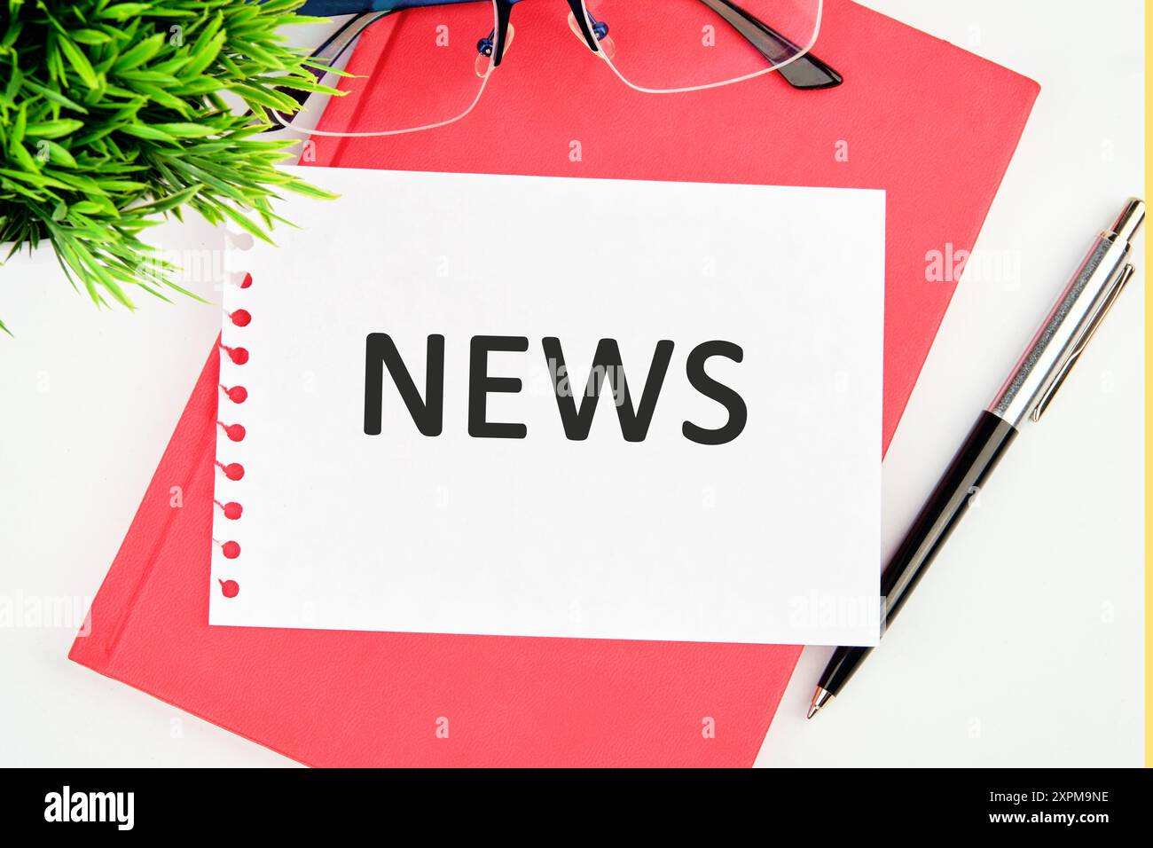 News word written in a white notebook on a red business book Stock ...