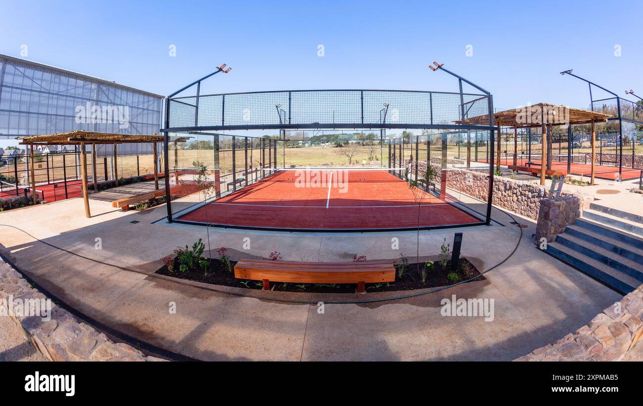 Padel Tennis game on red astro surface with glass walled enclosed ...