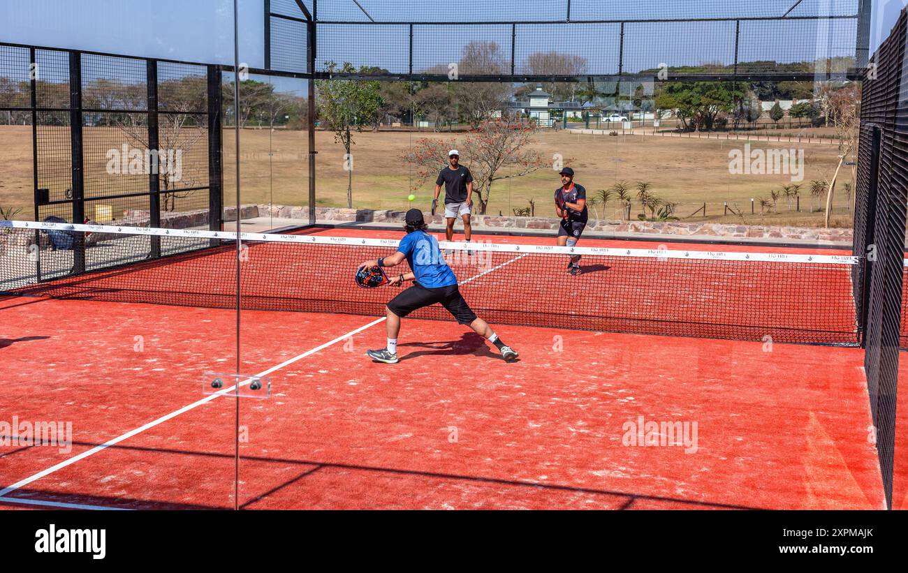Padel Tennis game action team doubles players on outdoor astro surface ...