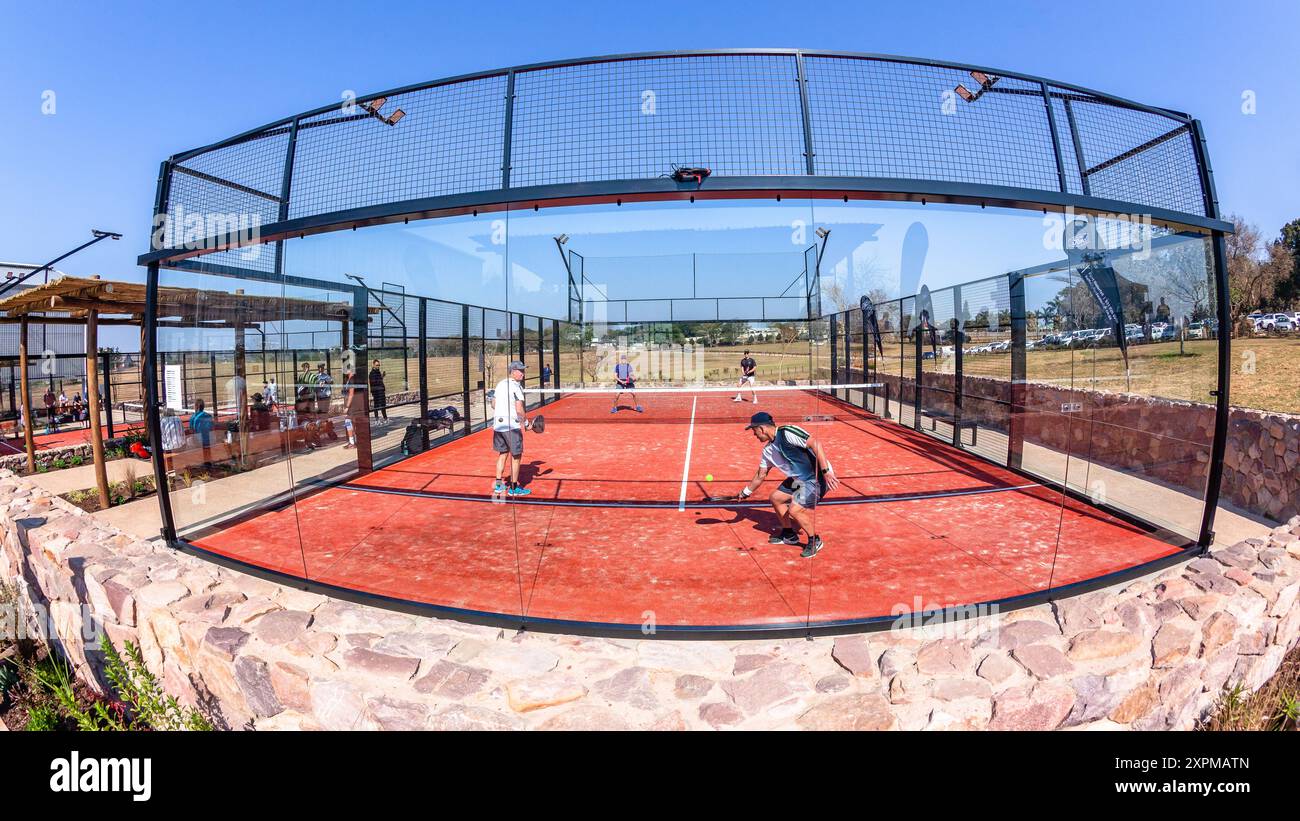 Padel Tennis game action team doubles players on outdoor red astro ...