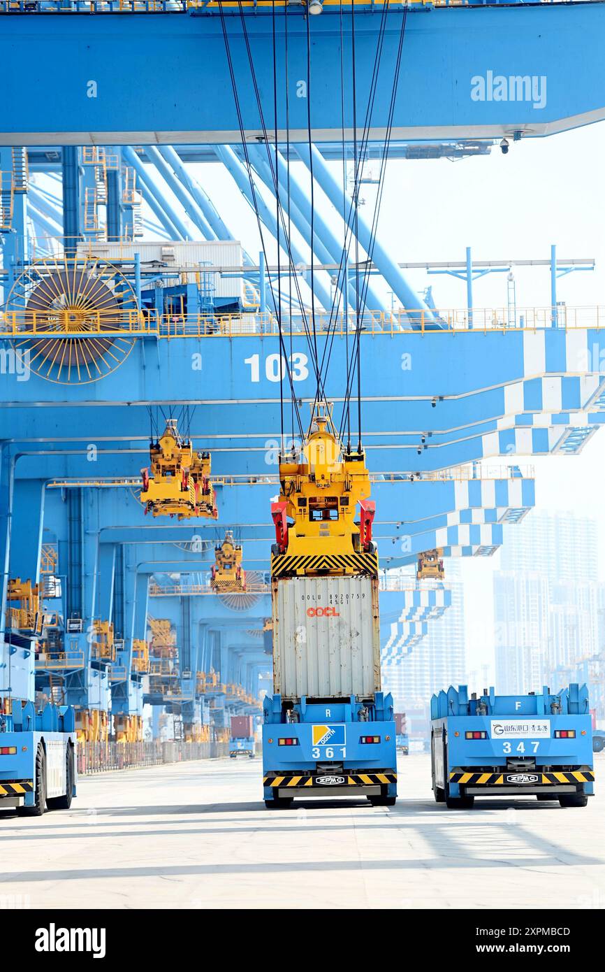 QINGDAO, CHINA - AUGUST 7, 2024 - Cargo ships load and unload foreign ...