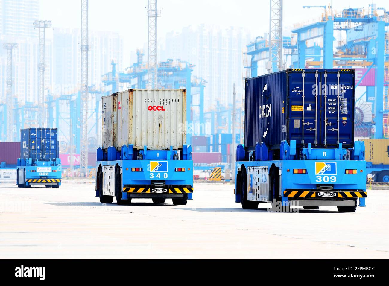 QINGDAO, CHINA - AUGUST 7, 2024 - Cargo ships load and unload foreign trade containers at the ...