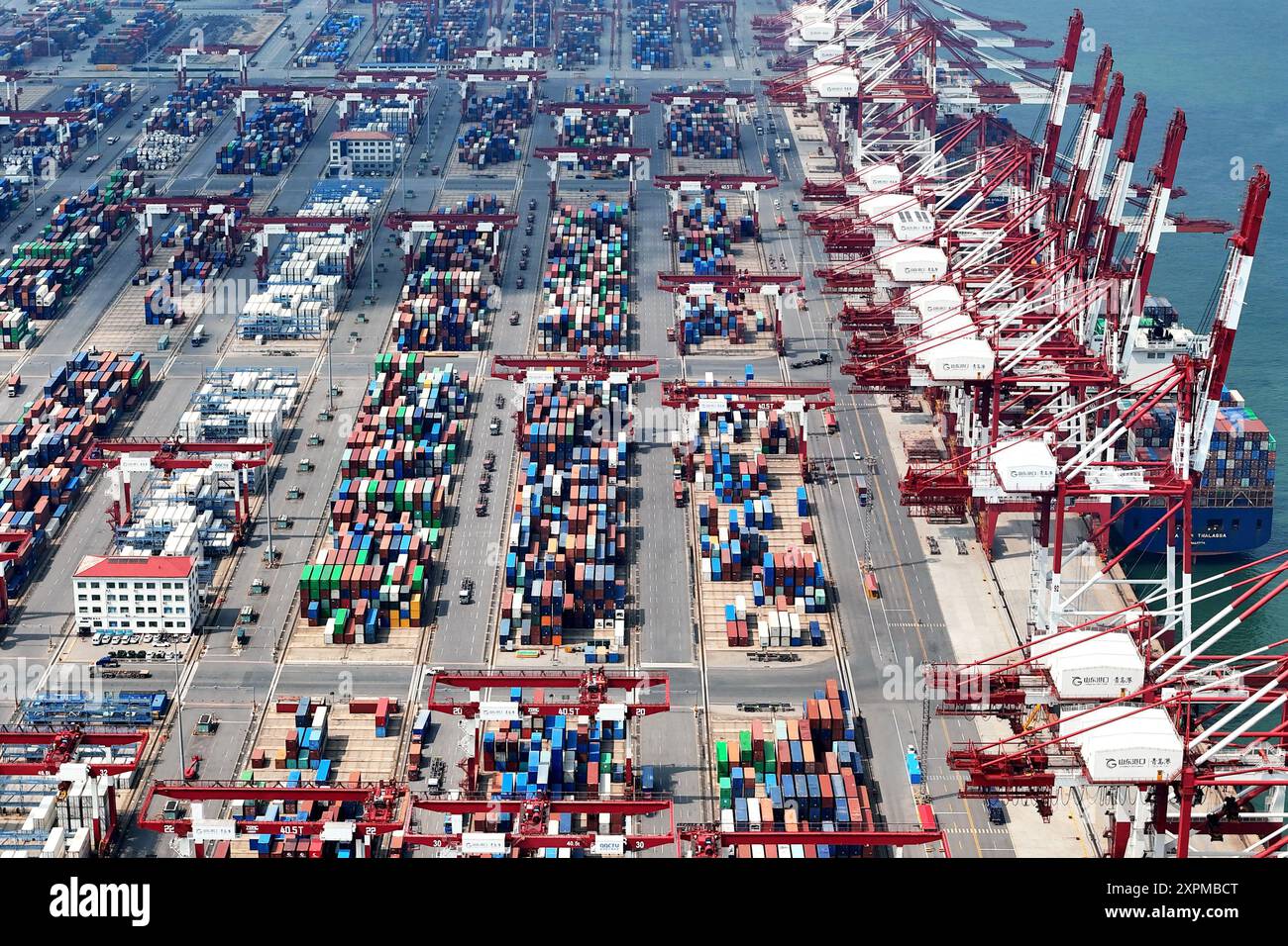 QINGDAO, CHINA - AUGUST 7, 2024 - Cargo ships load and unload foreign ...