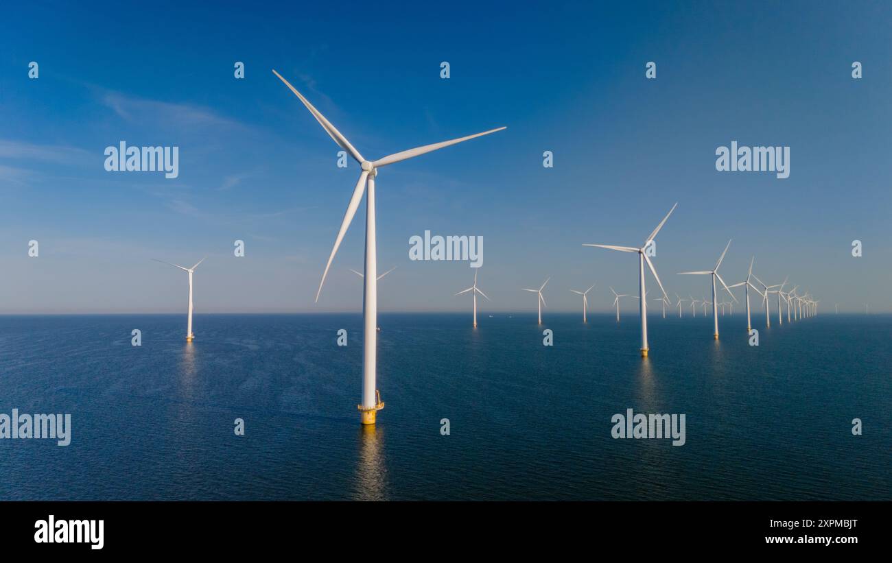 Tall wind turbines gracefully turn with the breeze, standing proudly in ...