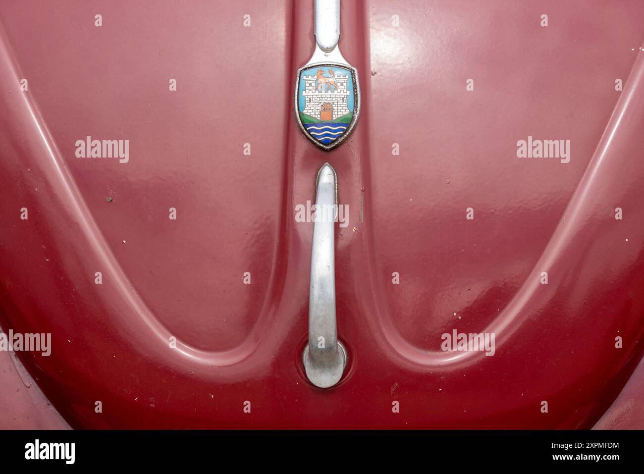 Symmetrical front view of a bright red Volkswagen Beetle with handle ...