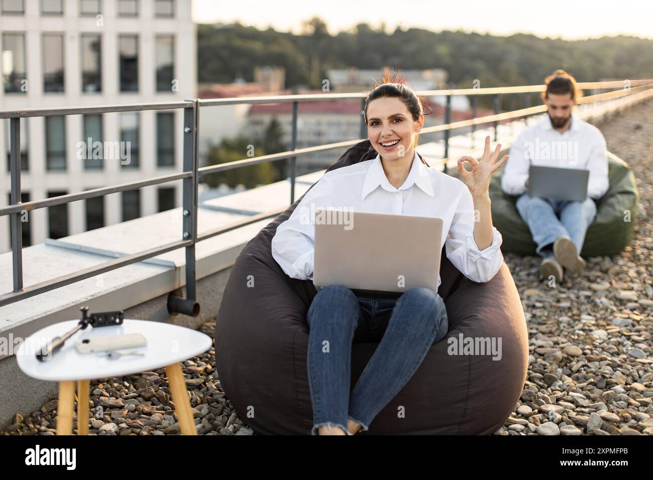 Remote working on rooftop with laptops and bean bags Stock Photo - Alamy