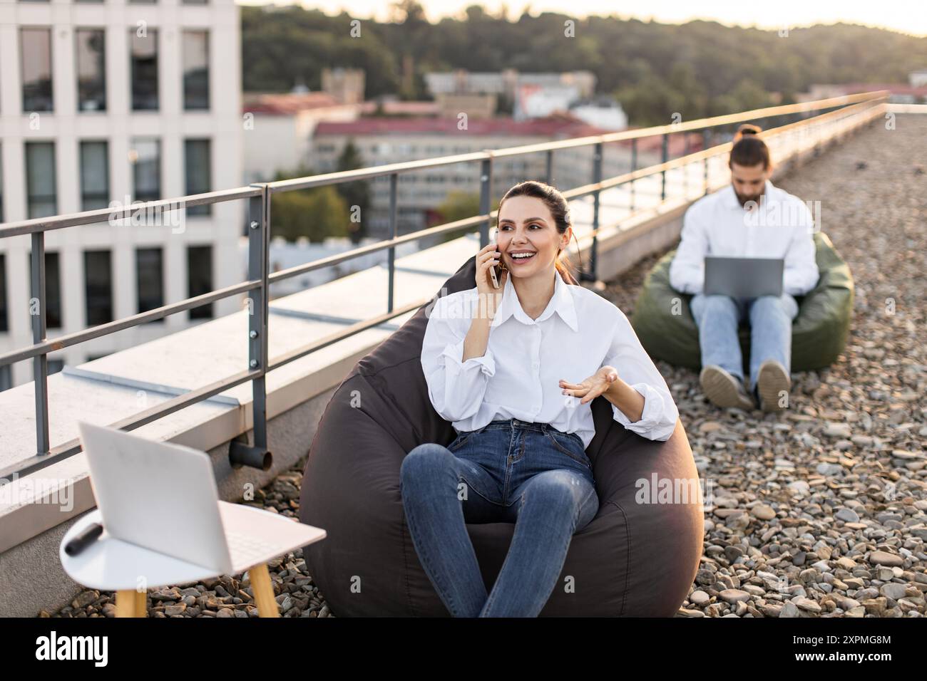 Outdoor workspace with people working on laptops and mobile phone Stock ...