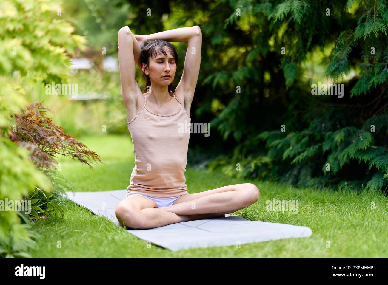 Woman stretching outdoors on yoga hi-res stock photography and images ...