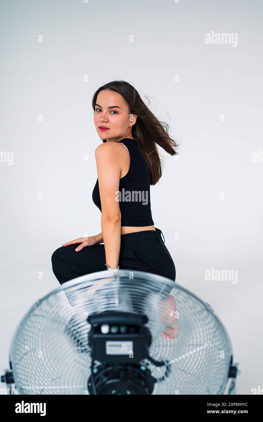 girl sitting in front of a fan Stock Photo - Alamy