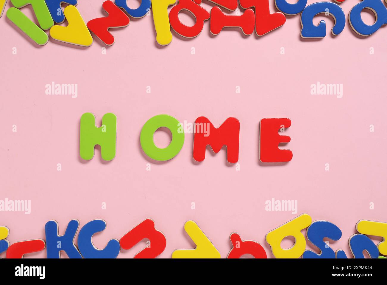 Word Home made of magnetic letters on pink background, flat lay ...