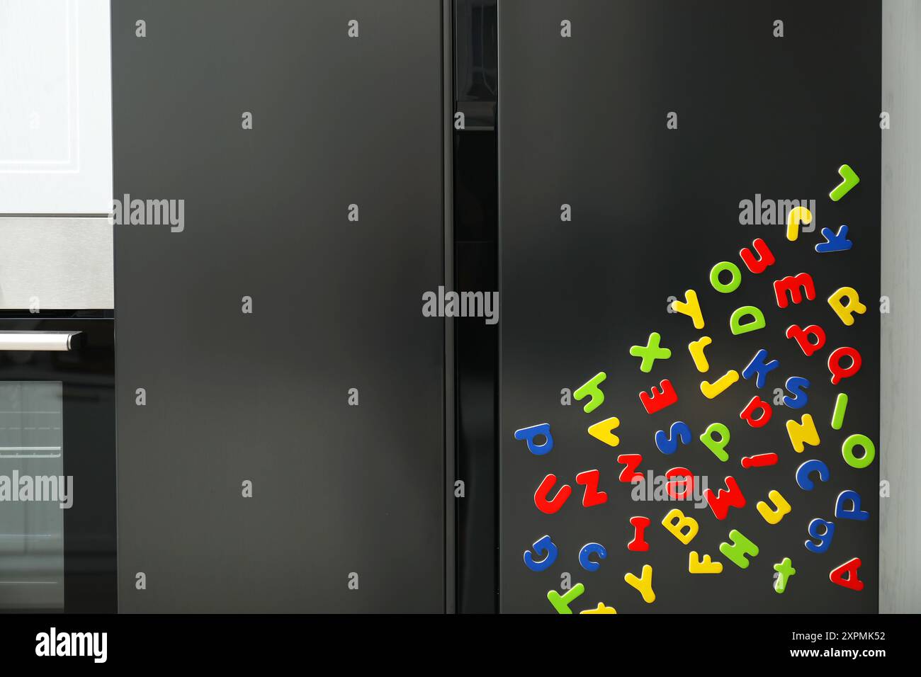 Many bright magnetic letters on fridge indoors. Learning alphabet Stock ...