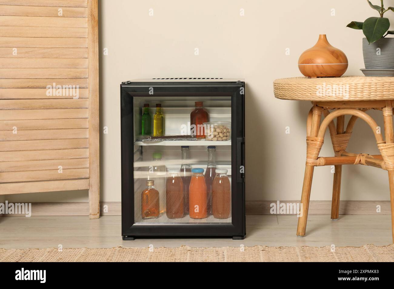 Mini refrigerator with drinks and snacks indoors Stock Photo - Alamy