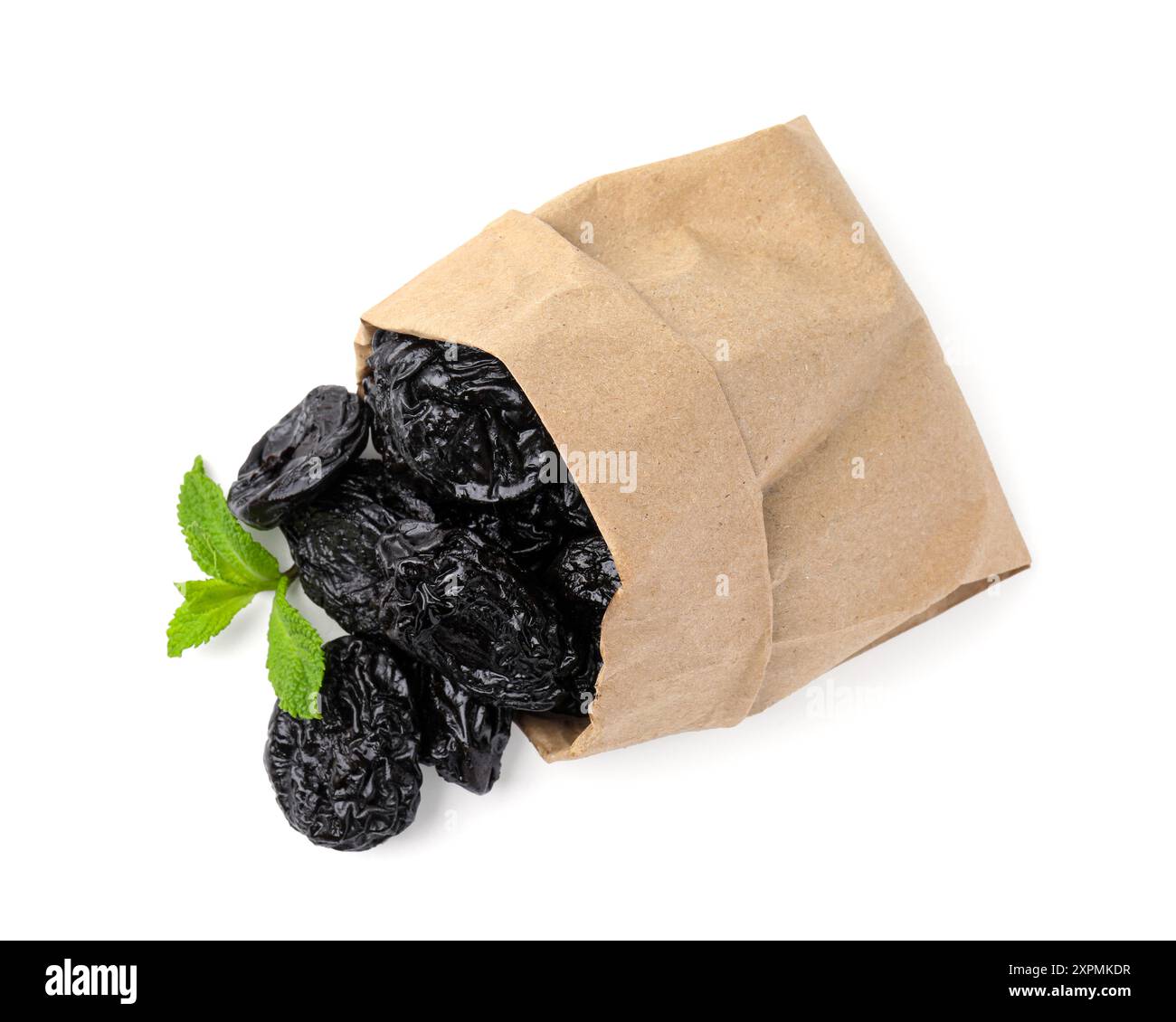 Paper bag with tasty dried plums (prunes) and mint isolated on white ...