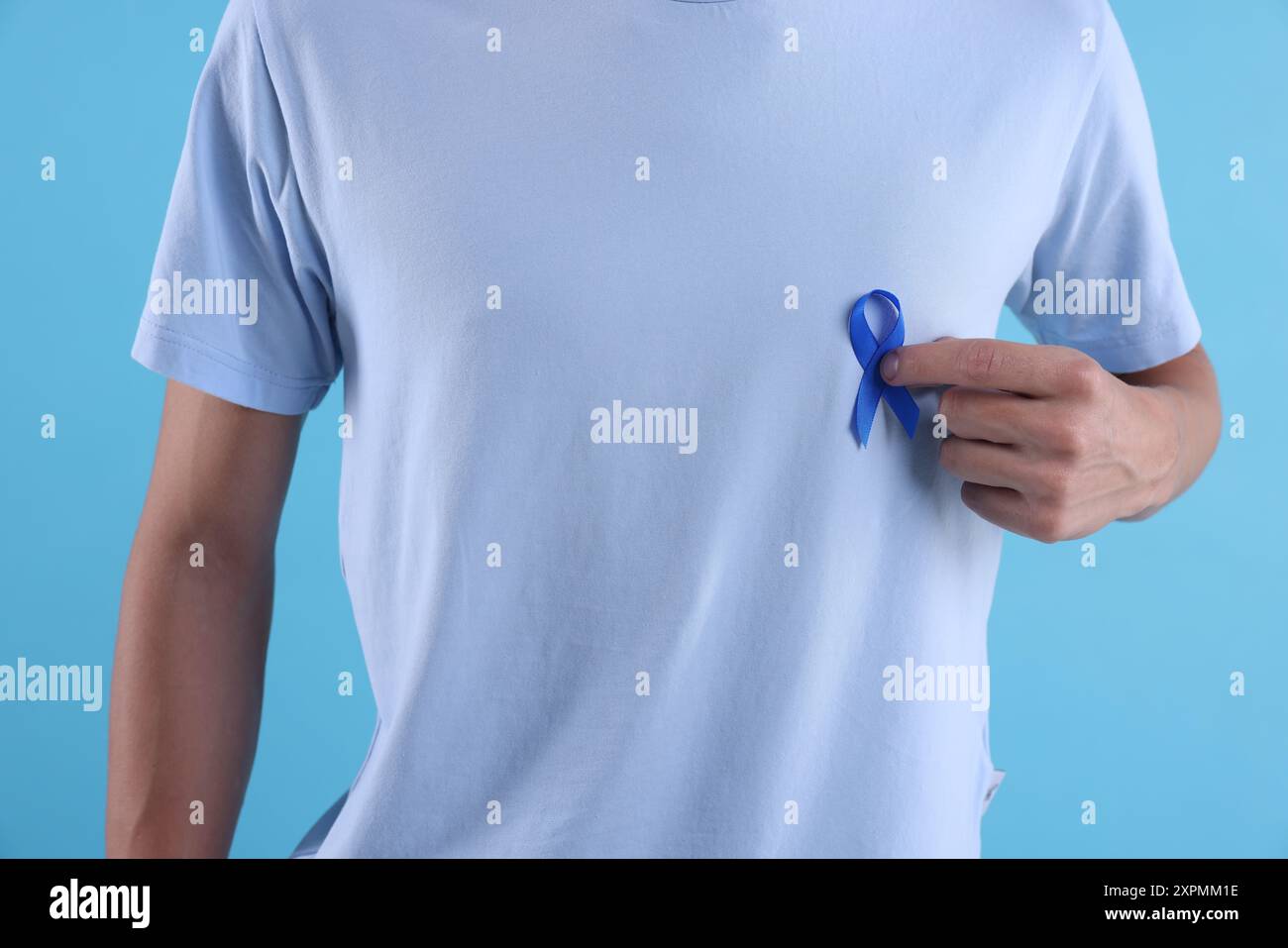 Prostate cancer awareness. Man with blue ribbon as symbol of support on ...