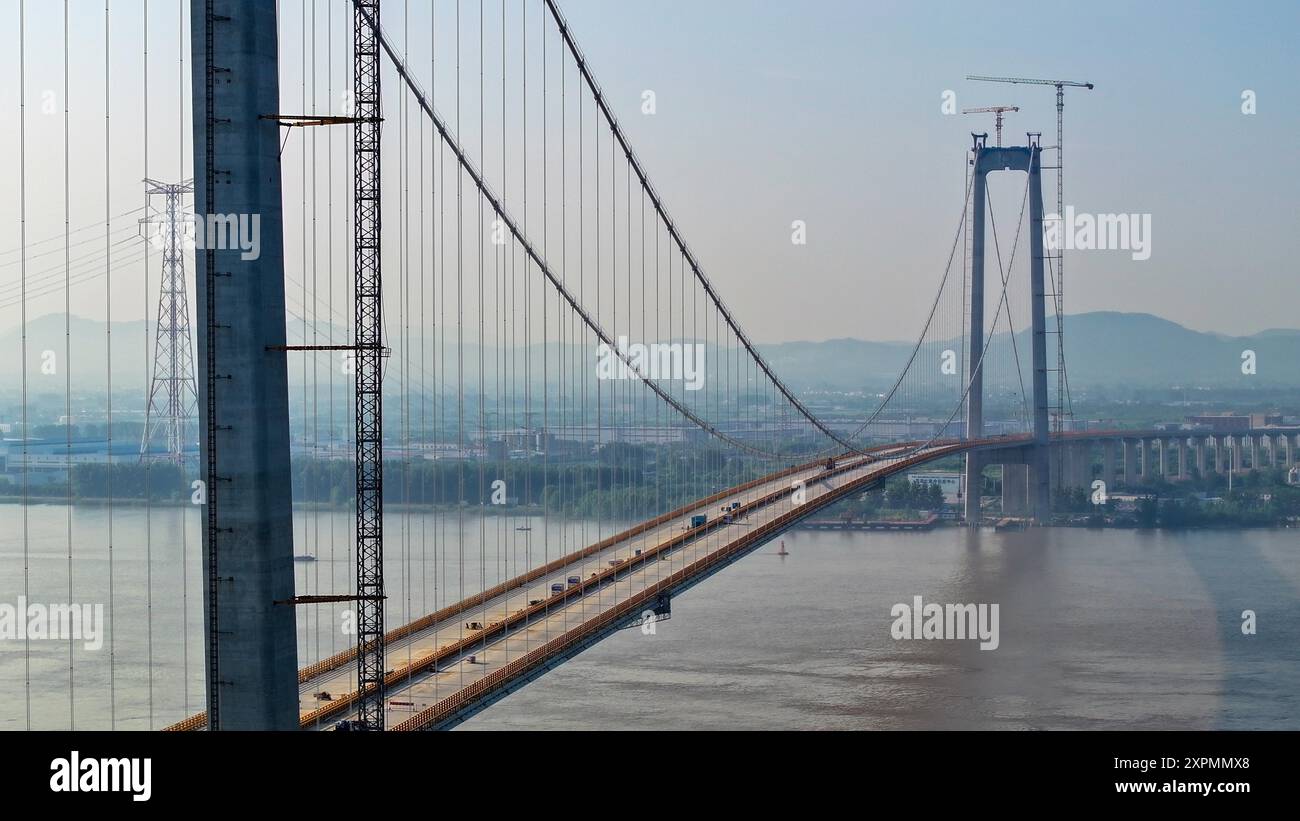 Aerial photo shows the Longtan Yangtze River Bridge under construction ...