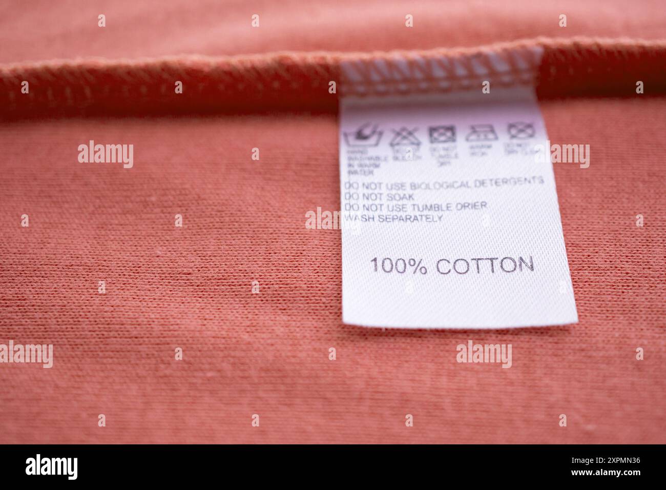 White laundry care washing instructions clothes label on cotton shirt ...