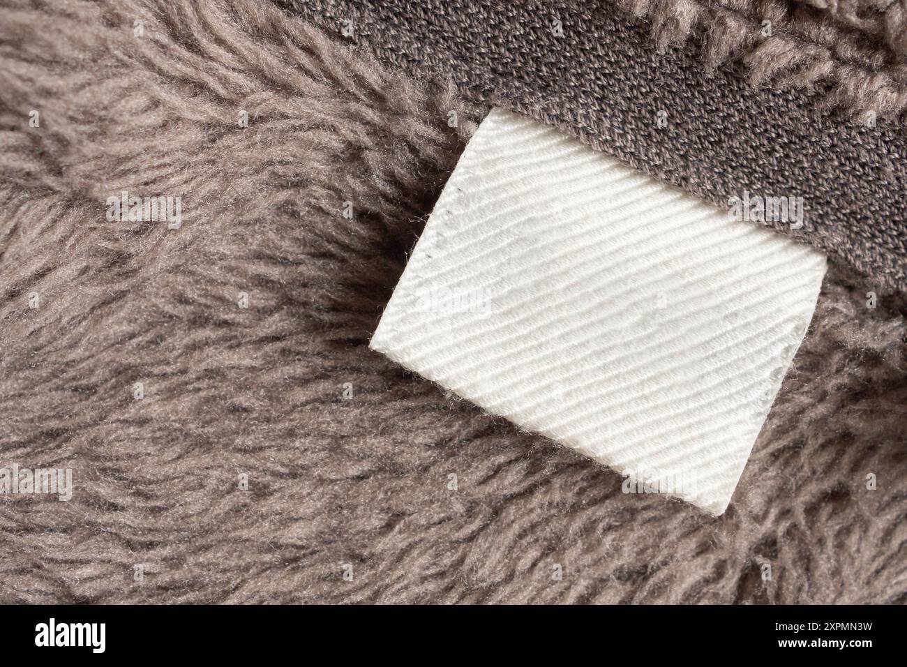 Blank white laundry care clothing label on fur texture background Stock ...