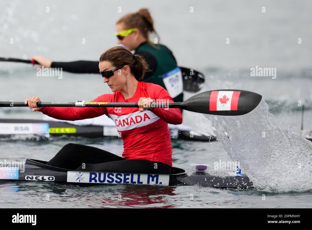 Michelle Russell, of Canada, front, competes in the women's kayak ...