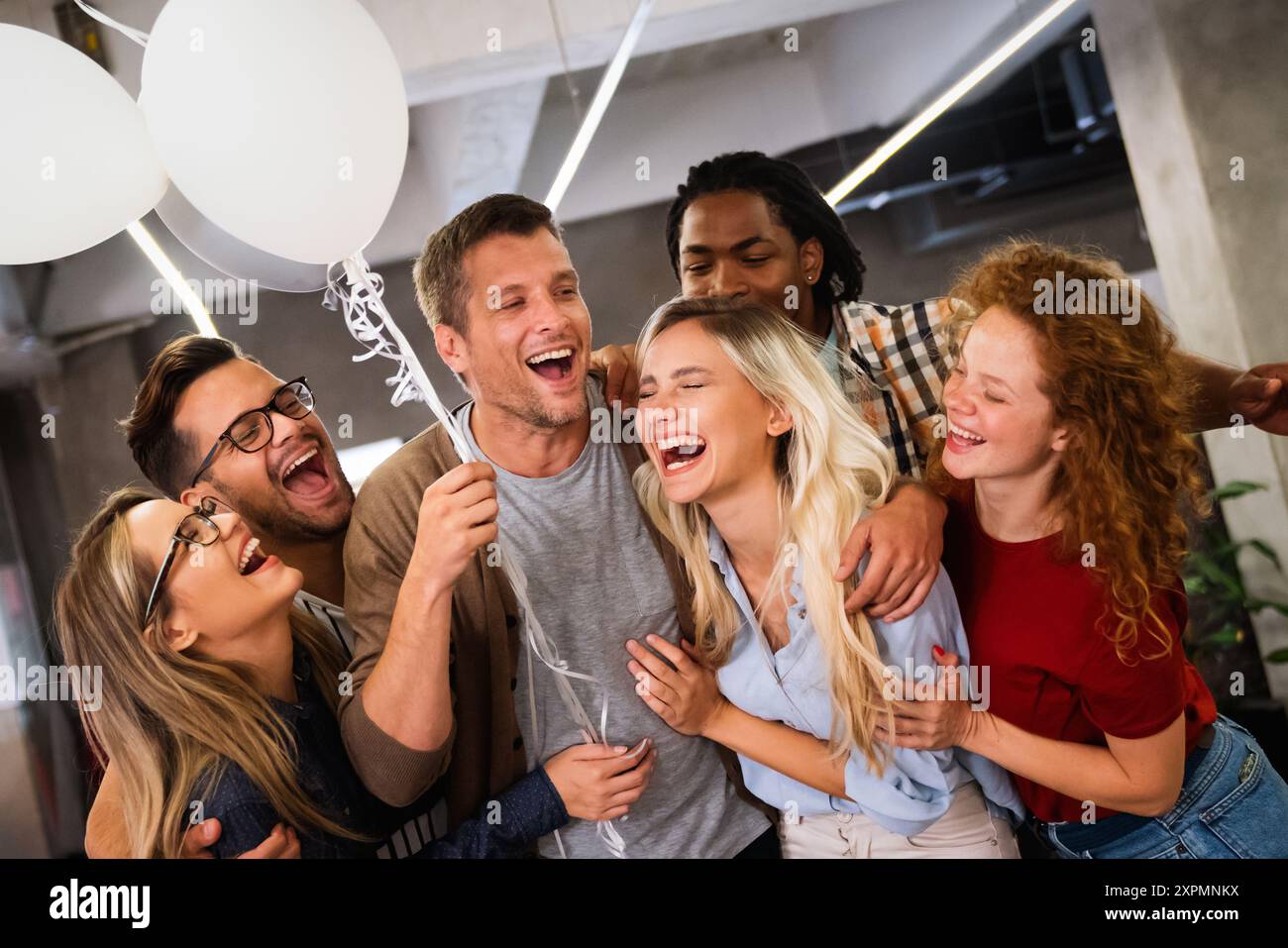 Happy business people celebrating success at company Stock Photo - Alamy