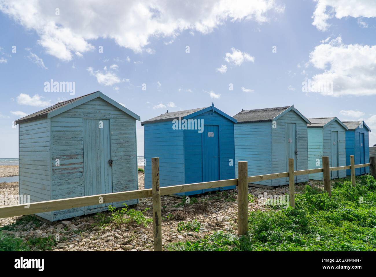 Five blue beach huts in a row on Charmouth Beach, Dorset Stock Photo ...