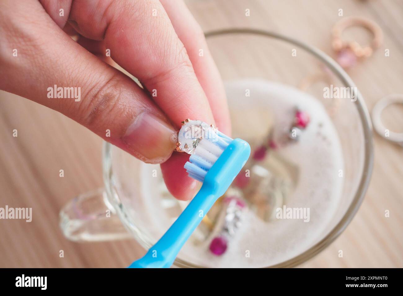 Jeweller hand cleaning and polishing vintage jewelry diamond ring ...