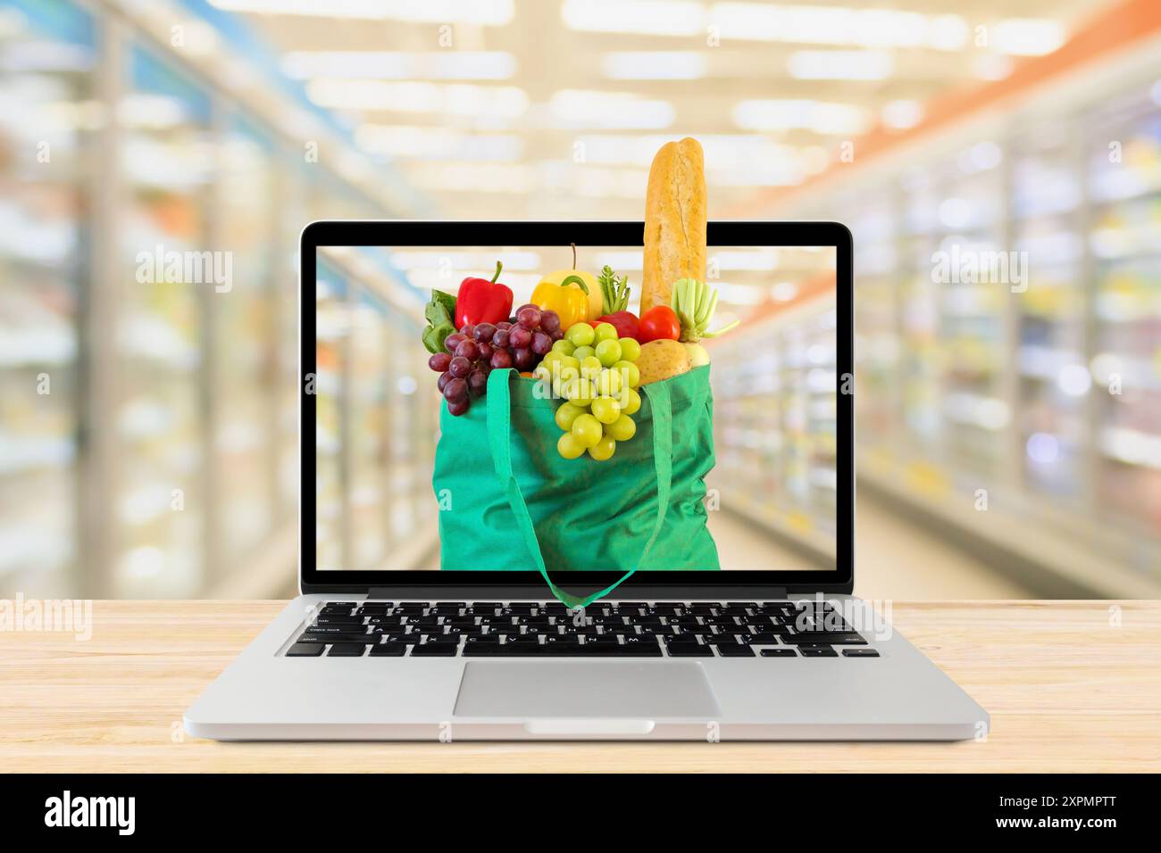 supermarket aisle blurred background with laptop computer and green ...