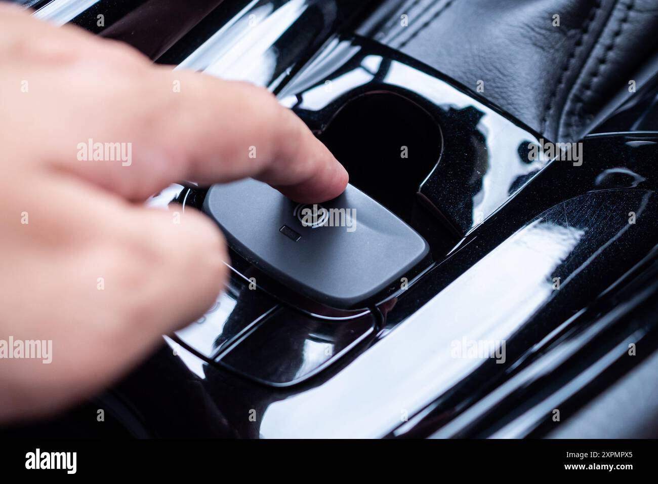 Hand push on electronic handbrake button in luxury modern car Stock ...