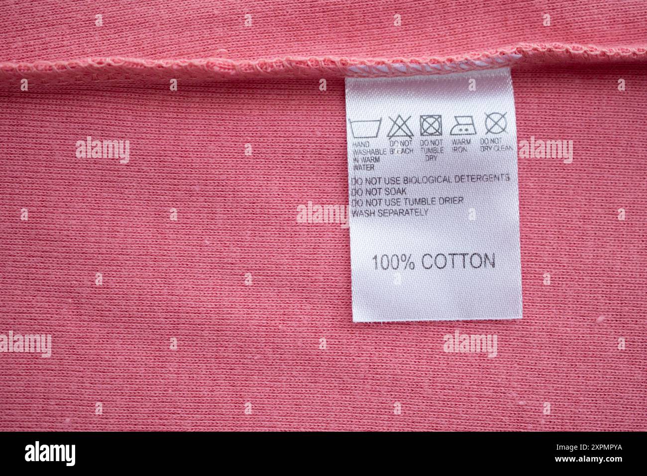 White laundry care washing instructions clothes label on cotton shirt ...