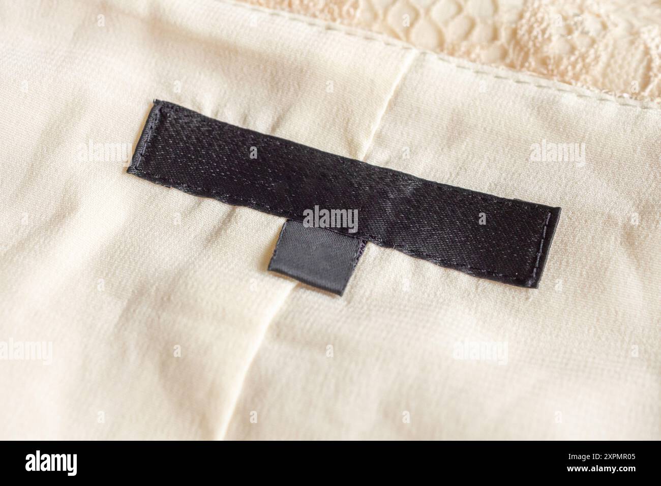 Blank black laundry care clothing label on fabric texture Stock Photo ...