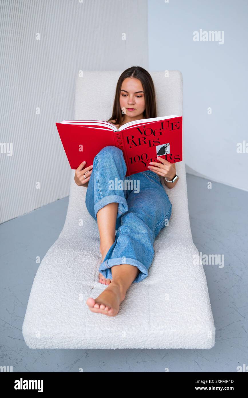 woman wth red book on the sofa Stock Photo - Alamy
