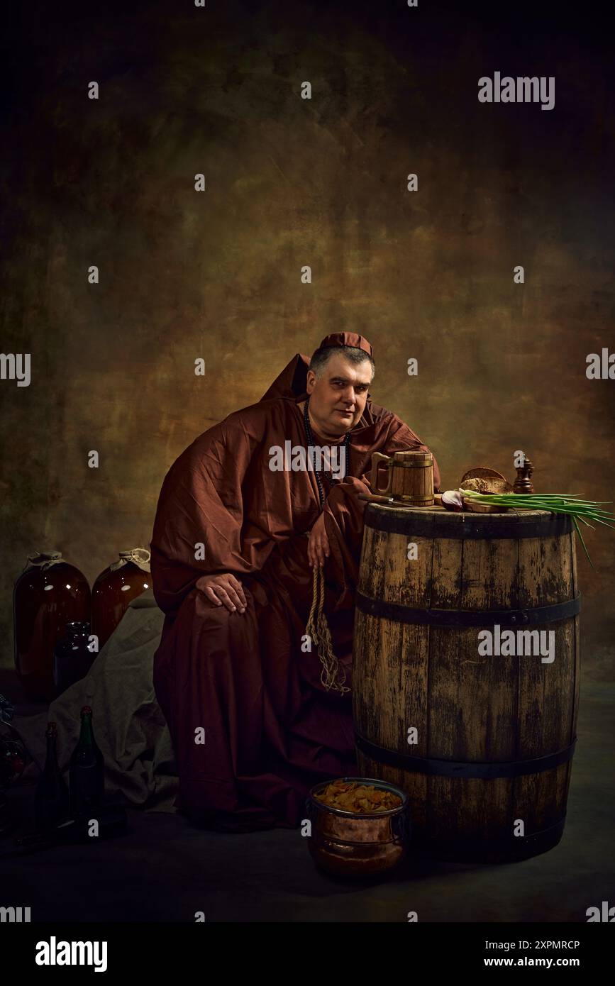 Portrait of medieval man, monk in period attire leaning on wooden ...