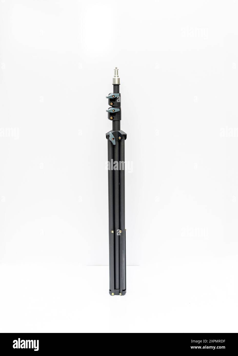 Tripod lighting stand on isolated white background Stock Photo - Alamy