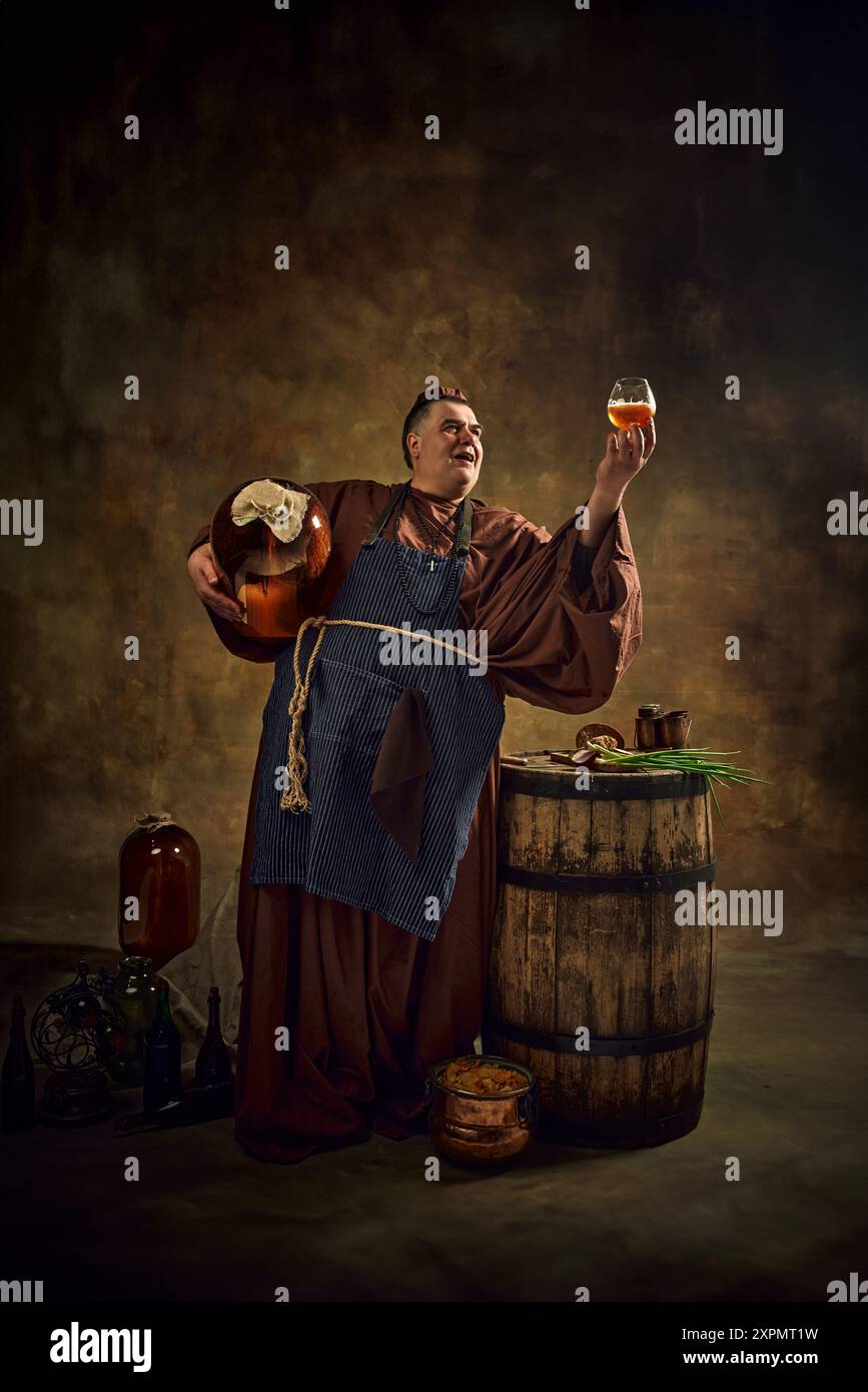 Medieval monk, man in period clothes with beer barrel and pint raising ...