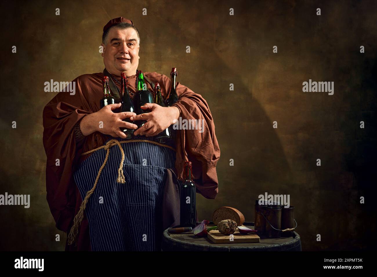 Delightful man, monk holding various bottles filled with beer, ale, and ...
