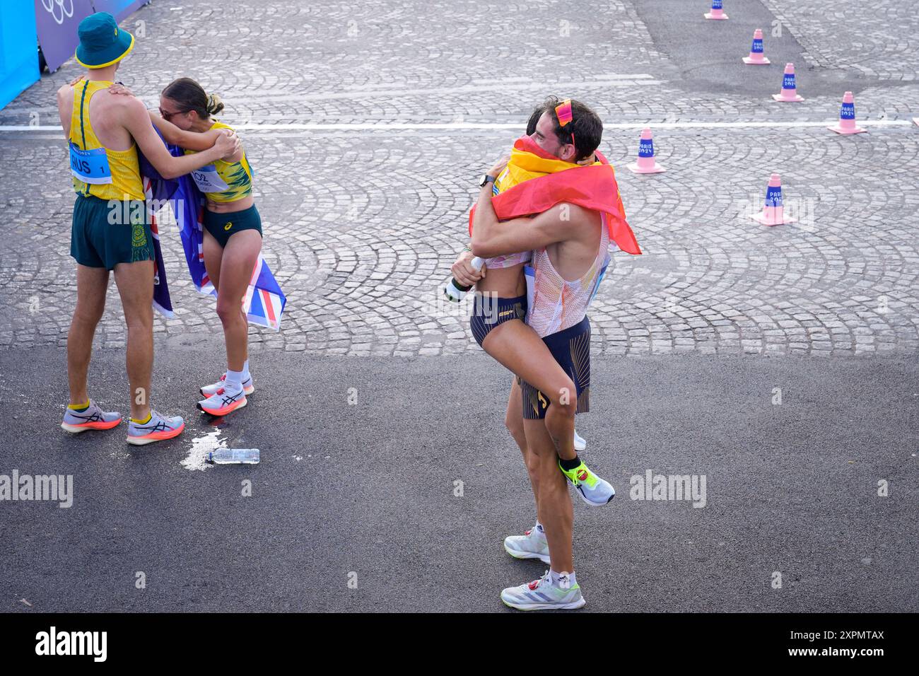 Spain's Maria Perez and Spain's Alvaro Martin embrace after crossing ...