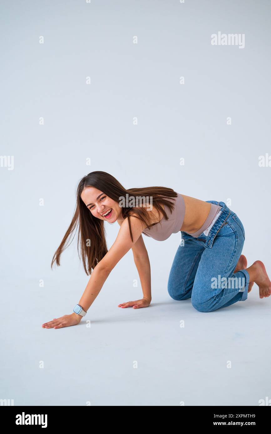 beautiful girl in a playful cat pose Stock Photo - Alamy