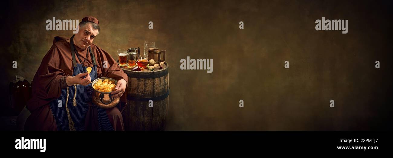 Medieval monk sitting in dimly lit cellar with wooden barrel of beer ...