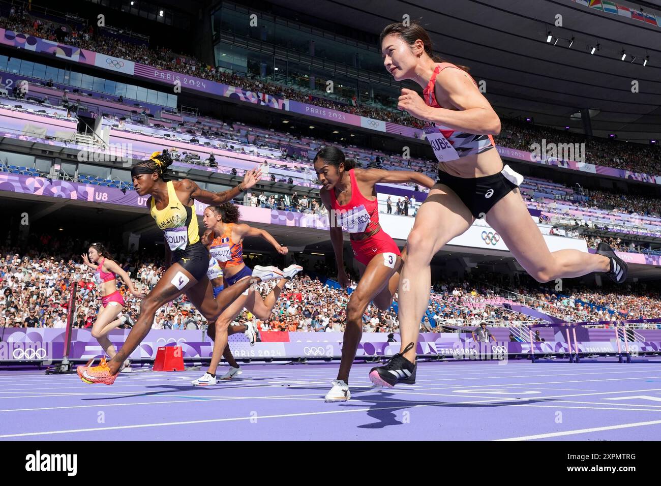 Mako Fukube, of Japan, right, crosses the finish line in the women's ...