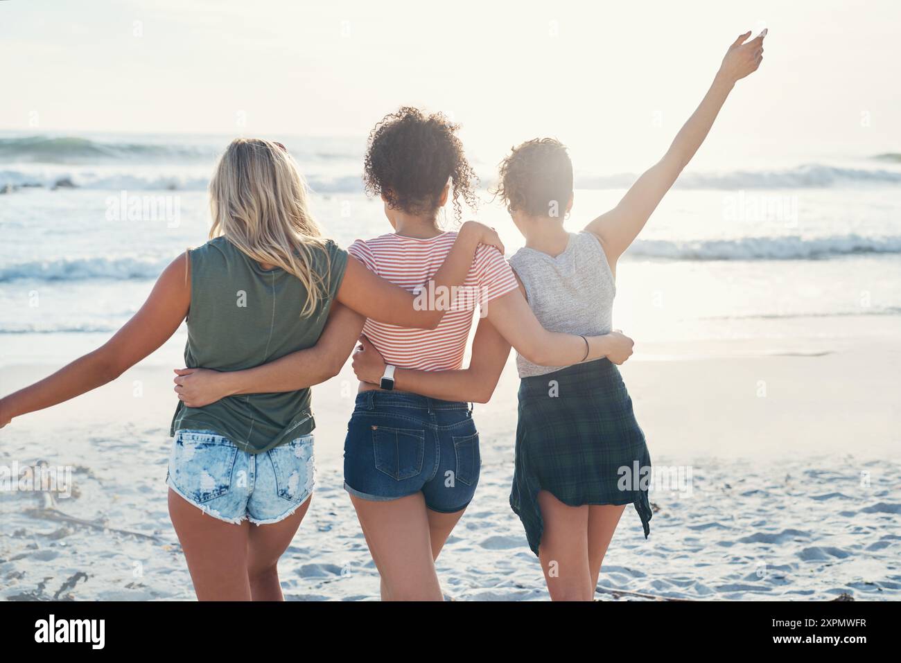 Back, hug and friends on beach for support, embrace and bonding ...