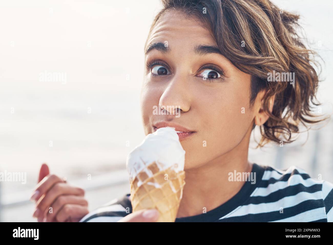 Woman, portrait and eating an ice cream outdoor for summer dessert ...