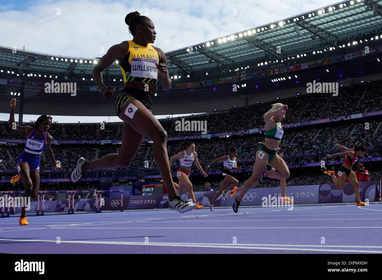 Danielle Williams, of Jamaica, crosses the finish line in the women's ...