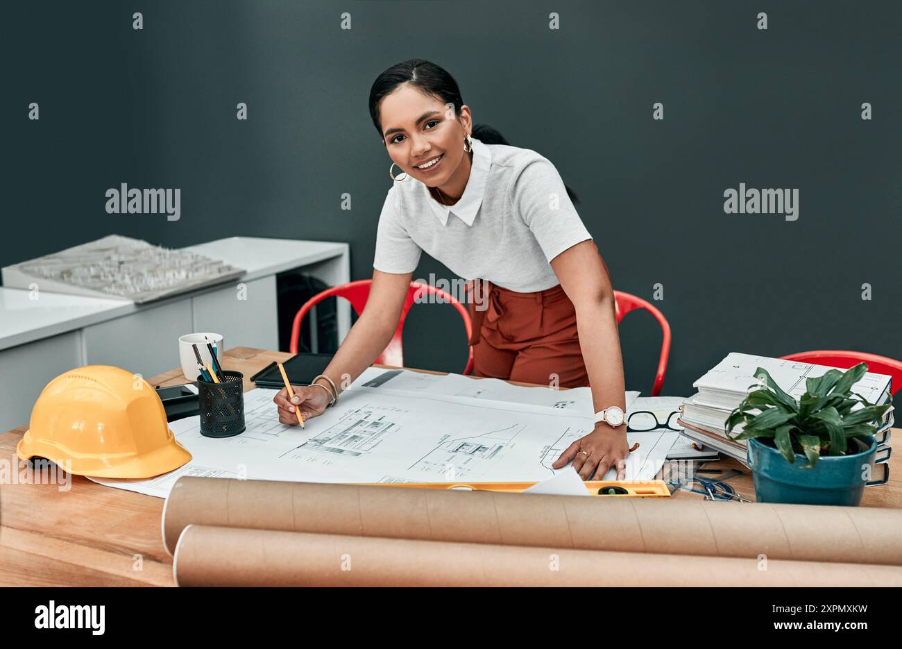 Portrait, architecture and woman at desk with blueprint, project ...