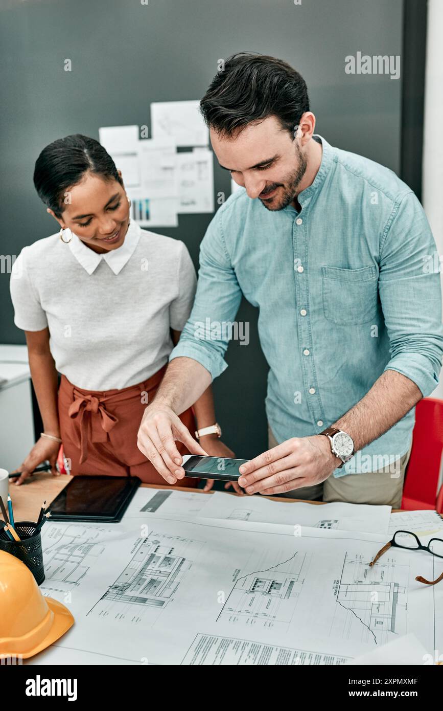 Man, architect and blueprint with phone for photo with woman ...