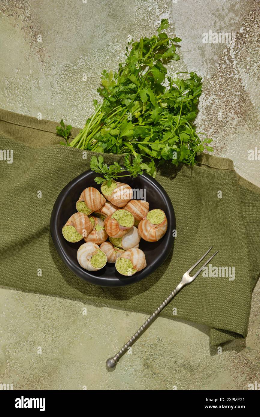 Overhead composition of edible snails baked in sauce and filled with ...