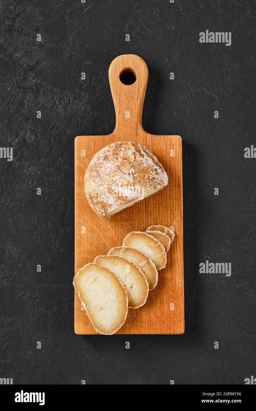 Overhead view of wooden chopping board with traditional Georgian cheese ...
