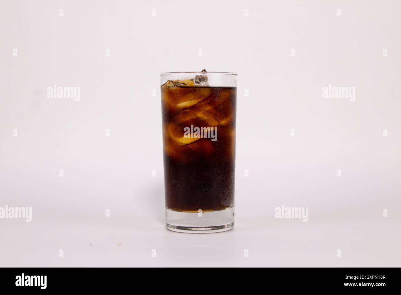 A glass of black cola with ice is filled on white background Stock ...