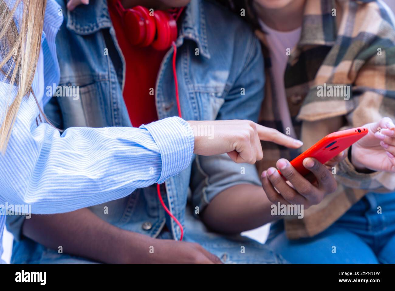 Three students having fun with mobile phones creating content on social ...