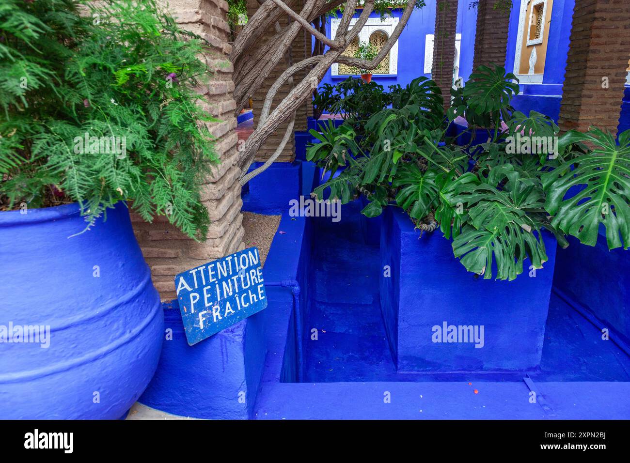 At the entrance to a patio, a sign warns: "Attention, fresh paint ...